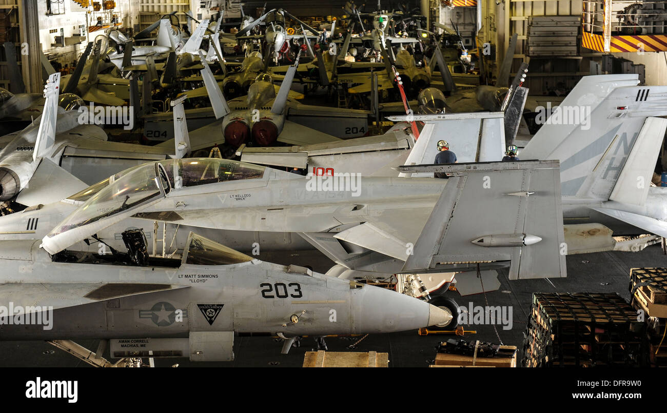 Aircraft assigned to Carrier Air Wing (CVW) 11 sit in the hangar bay ...