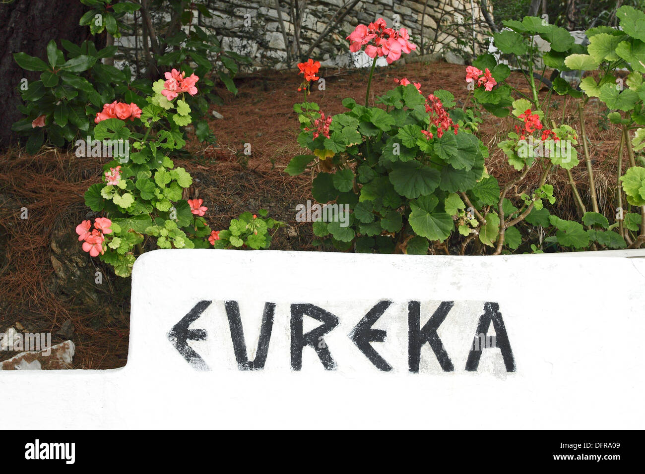 A house name 'EUREKA' in Greek lettering painted on the white outside ...