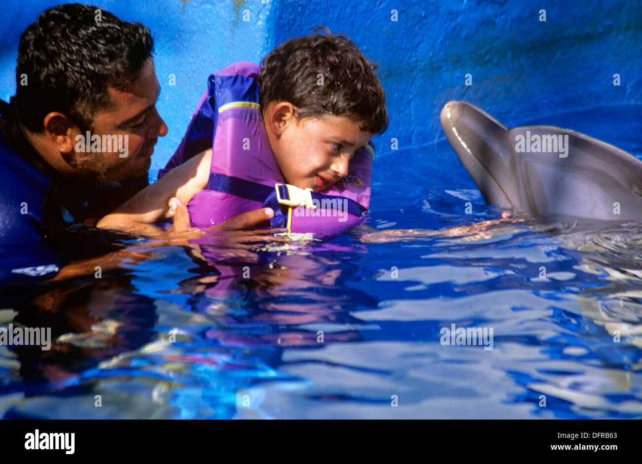 Kids enjoy a dolphin encounter at CICI Water Park, Acapulco, Mexico ...