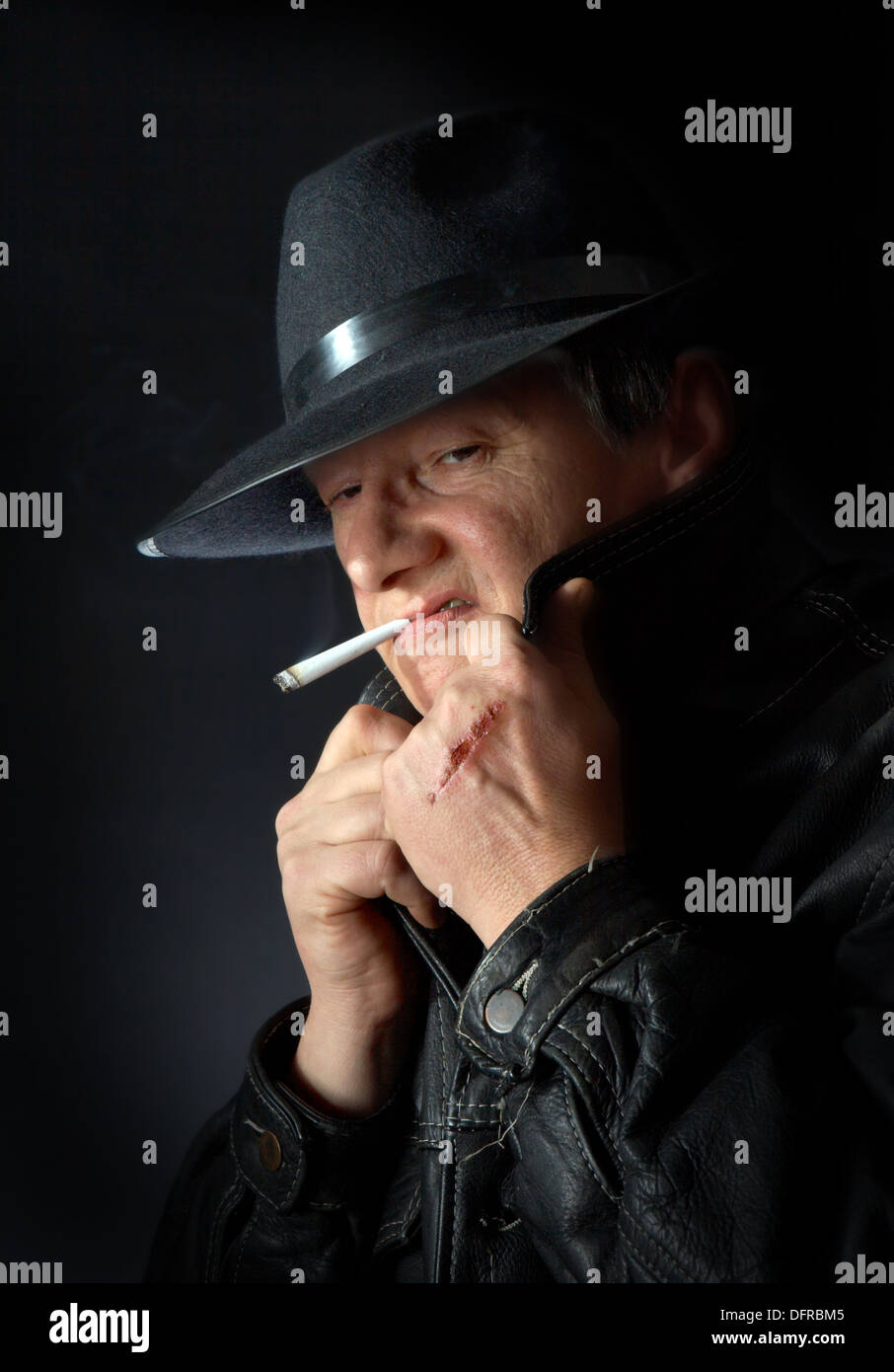Mafia type with scar on his hand, smoking a cigarette Stock Photo - Alamy