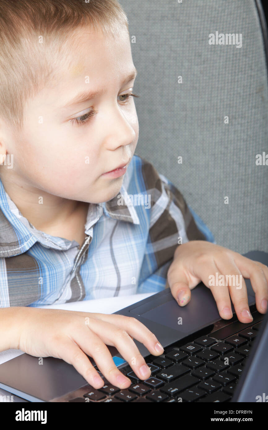 Computer addiction child boy with laptop notebook black background ...