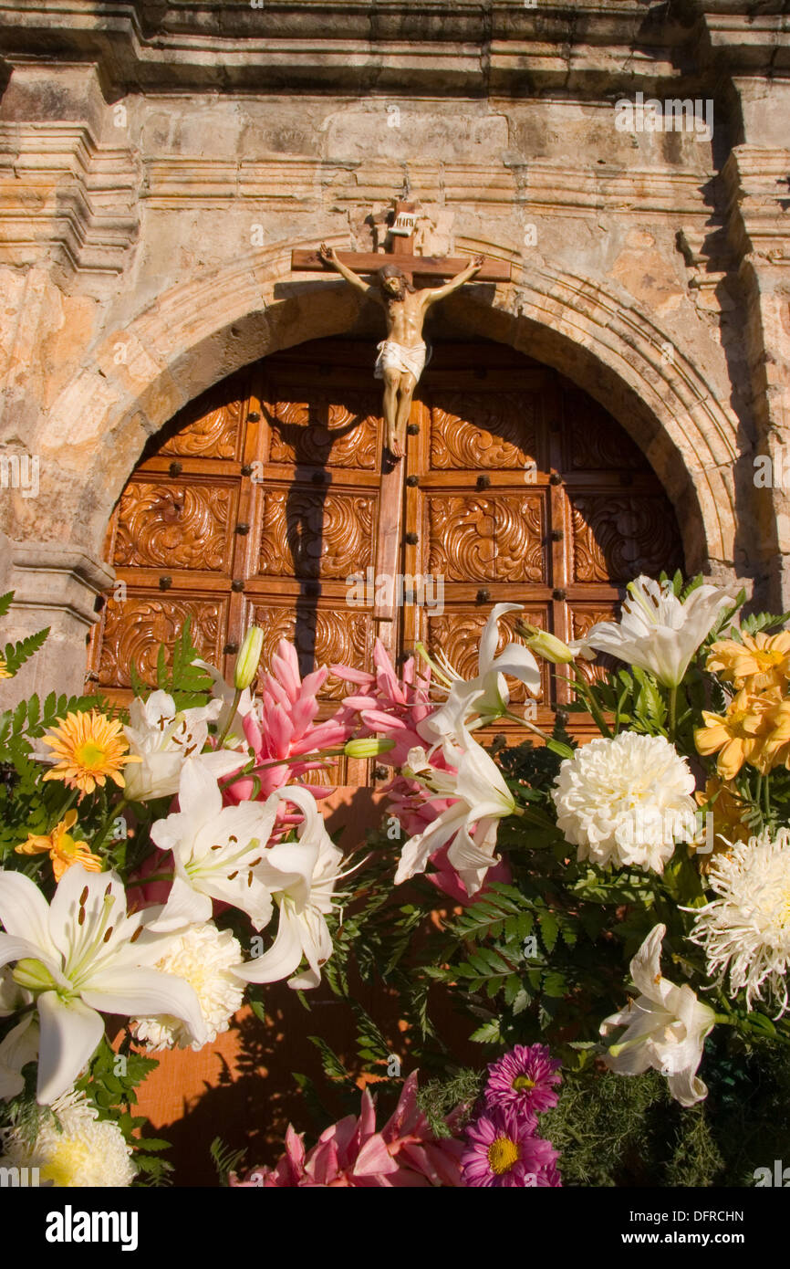Flower offerings add color at the entrance to the Iglesia de San Andras ...
