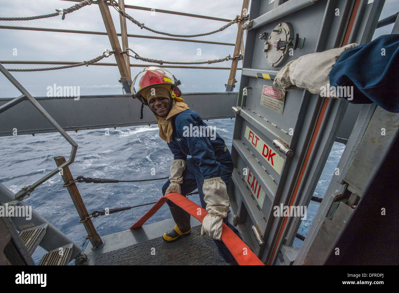 Seaman Jarren Waller mans a fire hose during a general quarters drill ...