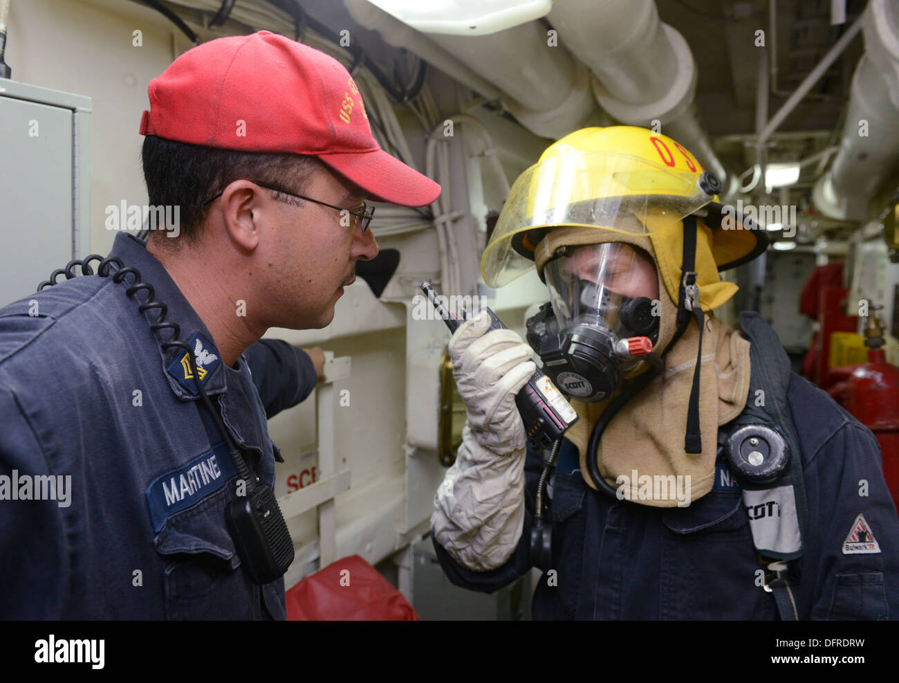 Damage Controlman 1st Class Peter Martinez, left, assesses Damage ...