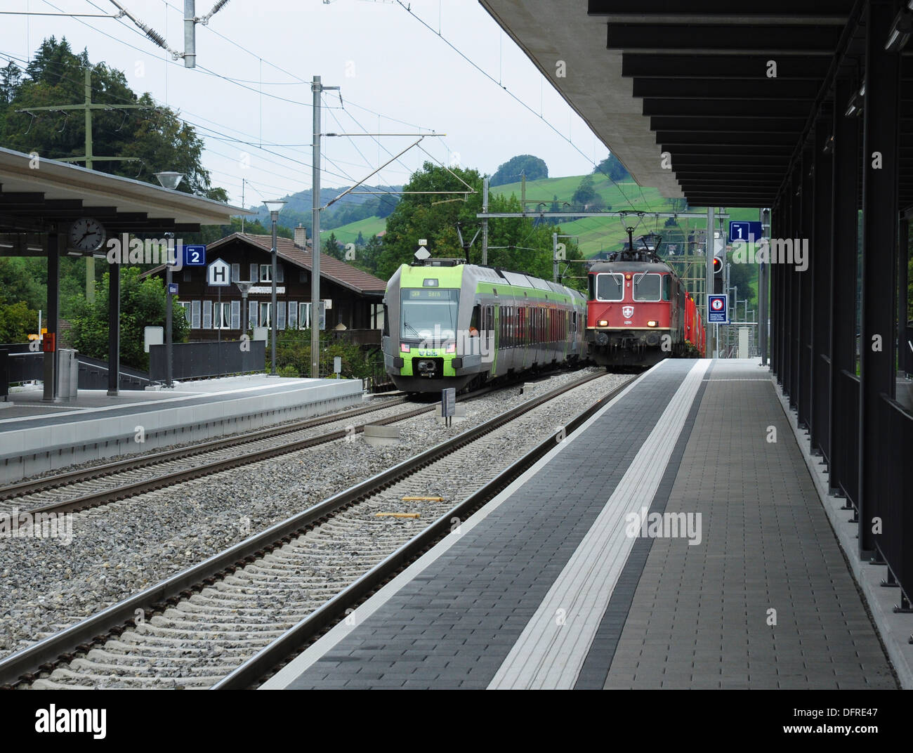 BLS passenger train for Bern passing a freight train at Mulenen station ...