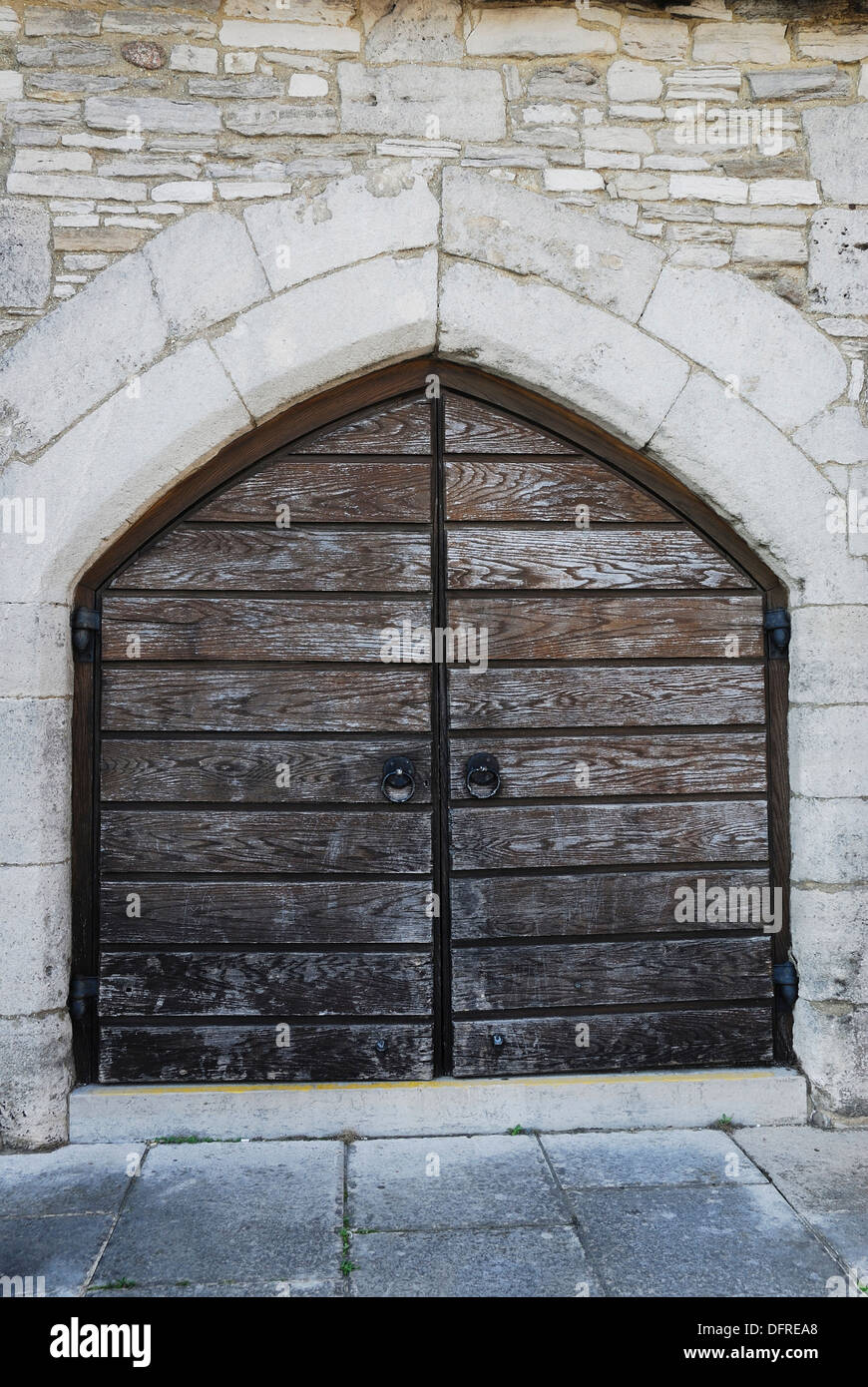 Sturdy wooden doors set into a stone building UK Stock Photo - Alamy
