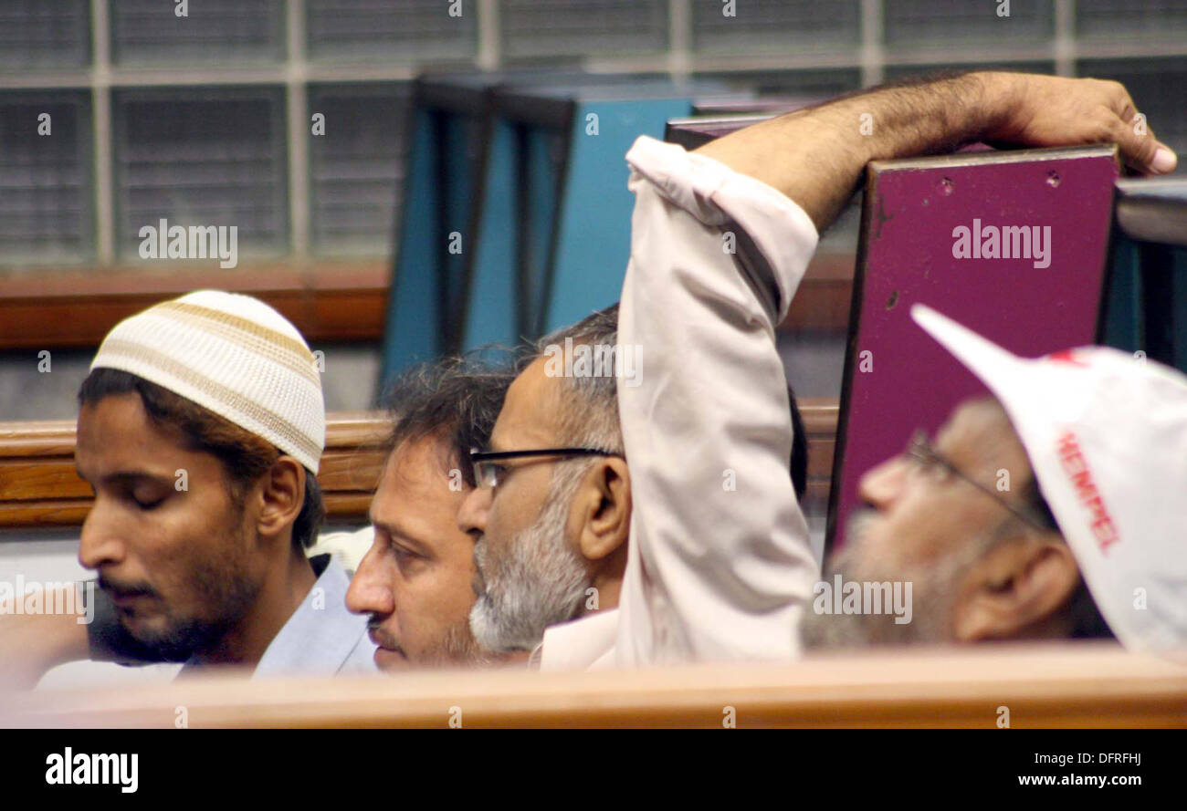 Pakistani traders monitor shares prices at the Karachi Stock Exchange ...