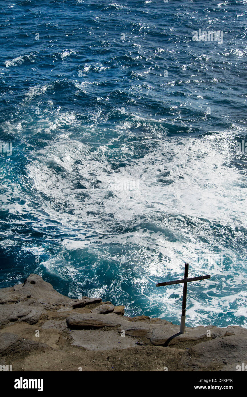 Cross at the point of a deadly accident on a dangerous cliff by ocean ...
