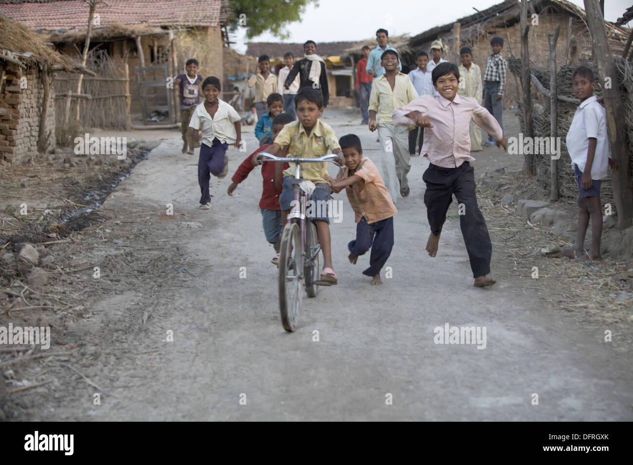 Tribal children riding bicycle, Madhya Pradesh, India Stock Photo - Alamy