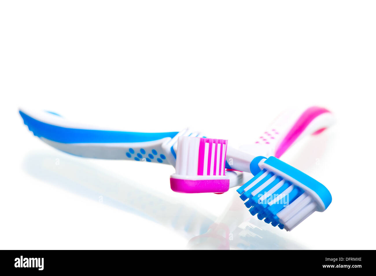 two toothbrushes crossed on a white background Stock Photo - Alamy