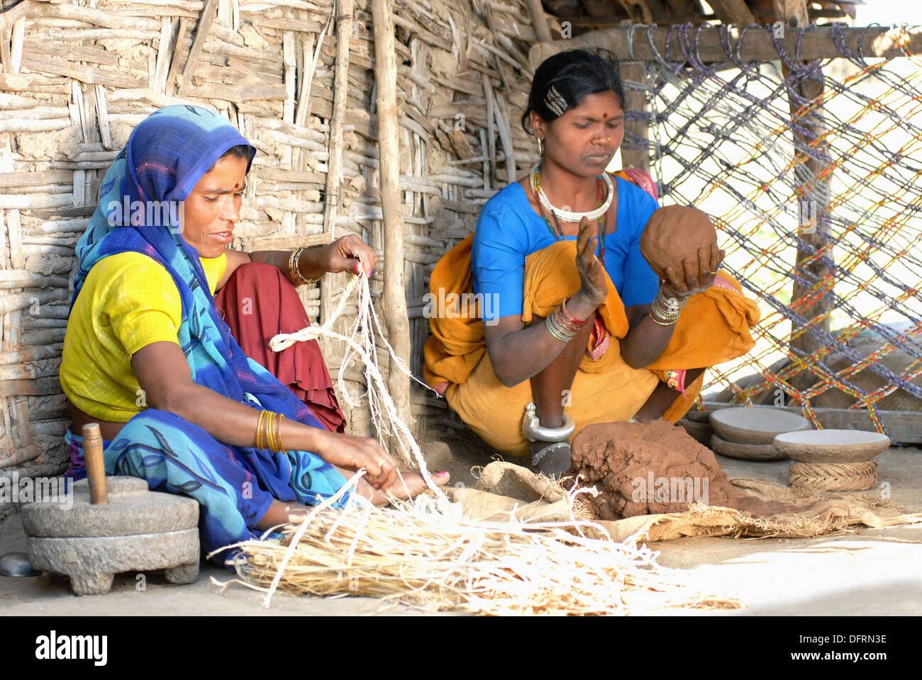 Bareli Tribal women making rope and earthen pots, Madhya Pradesh, India ...