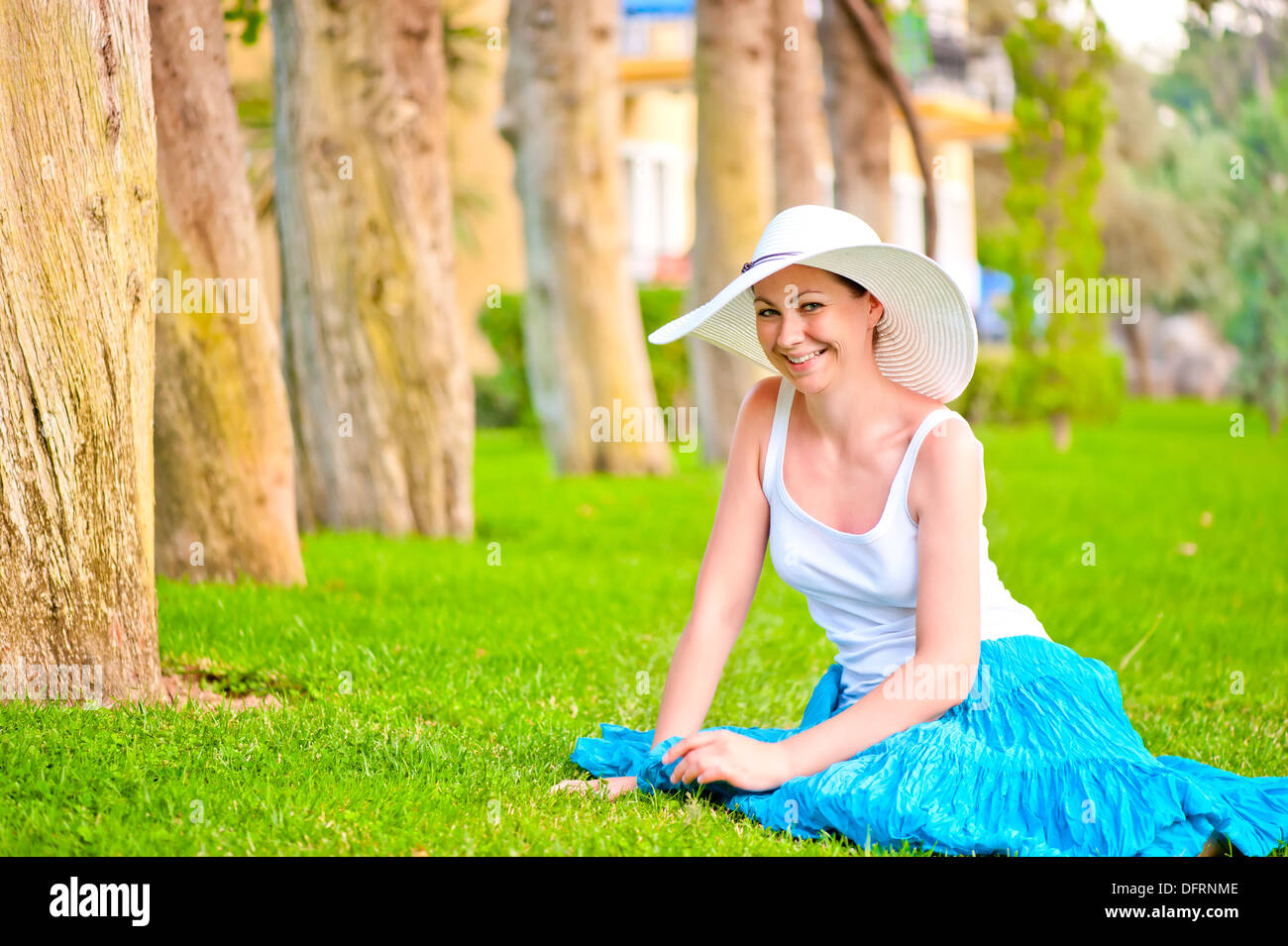 Girl resting on the lawn and laughs gaily Stock Photo - Alamy