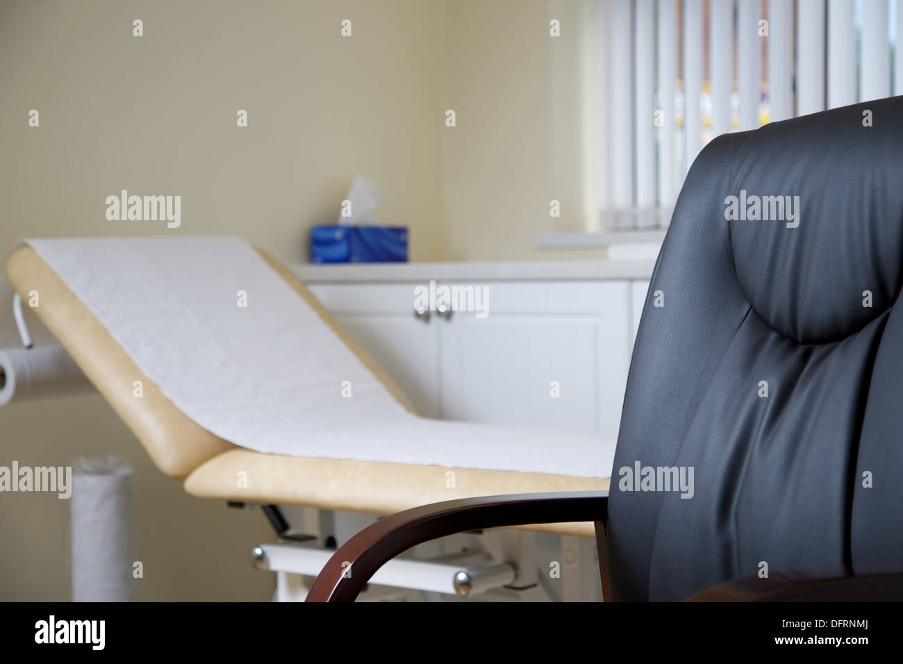 Interior of a GP doctor's surgery with an empty chair and bed Stock ...