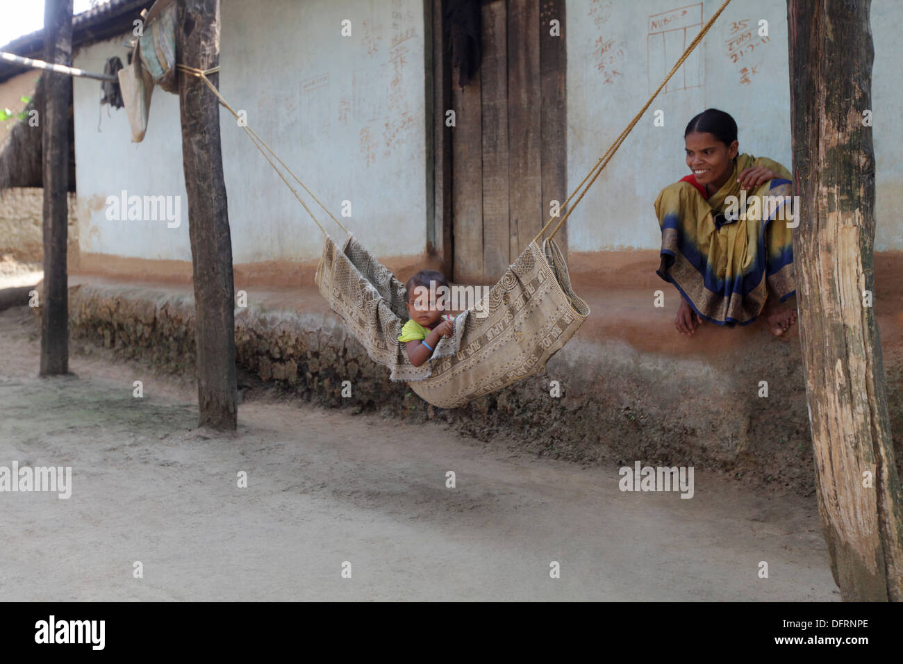 Mother looking at a child in a hammock, Madia tribe, Bhamragad ...