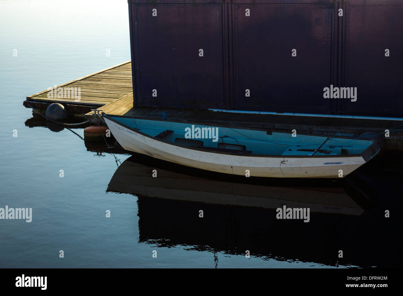 autumn rowing boat dock reflection claim waves Stock Photo - Alamy