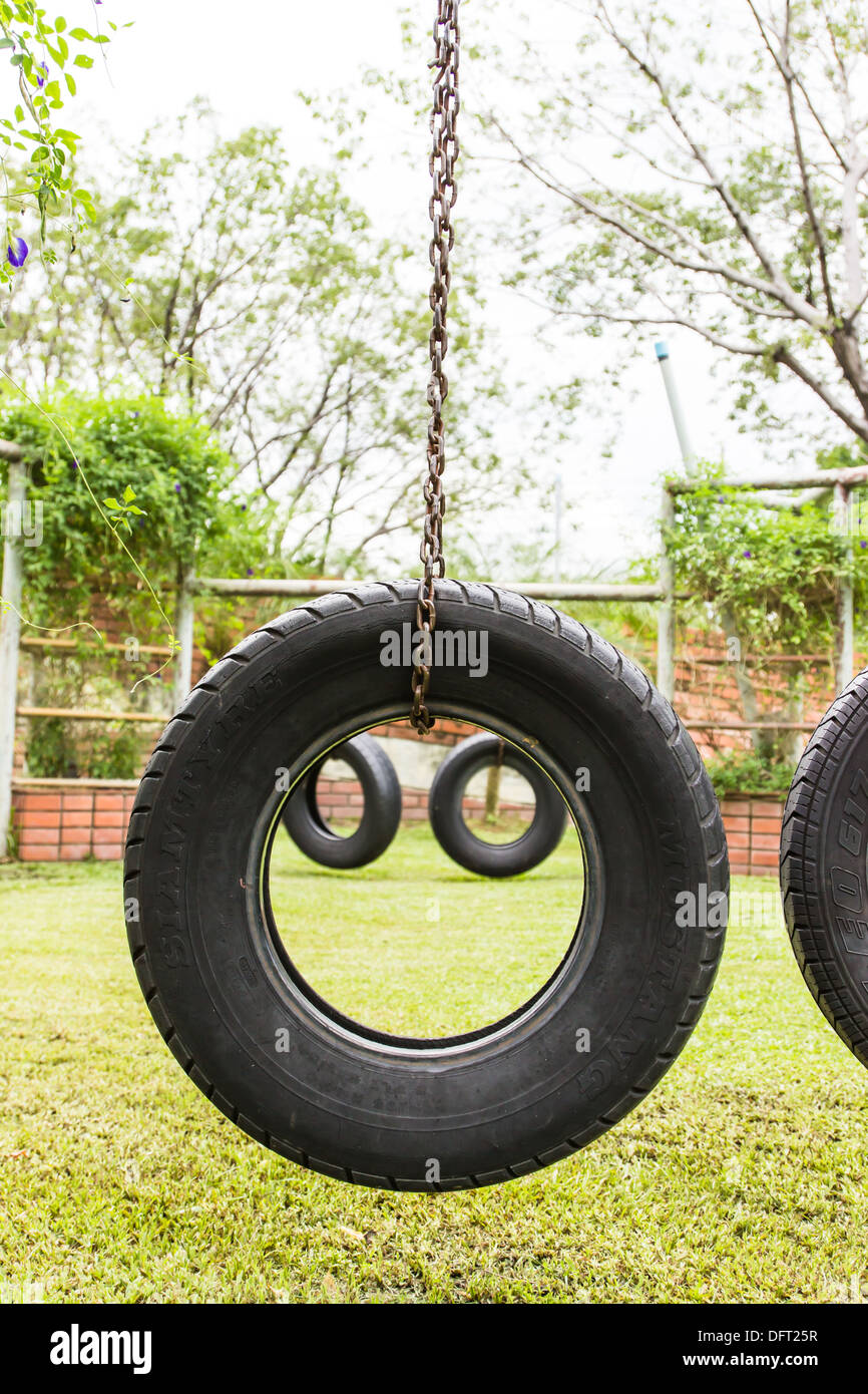 Tyre swing in garden playground Stock Photo - Alamy
