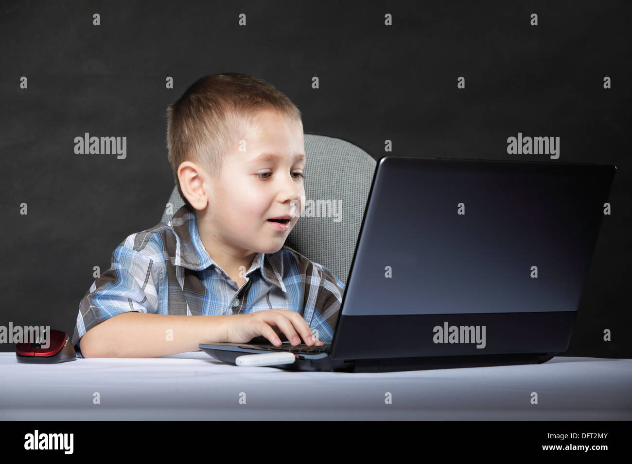Computer addiction child boy with laptop notebook black background ...