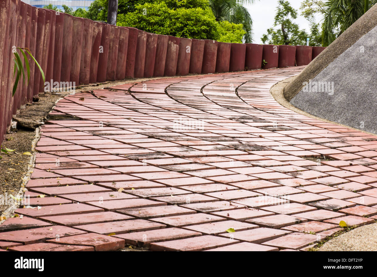 Sidewalk Curving walk from Paving Stones and wood walls garden Stock ...
