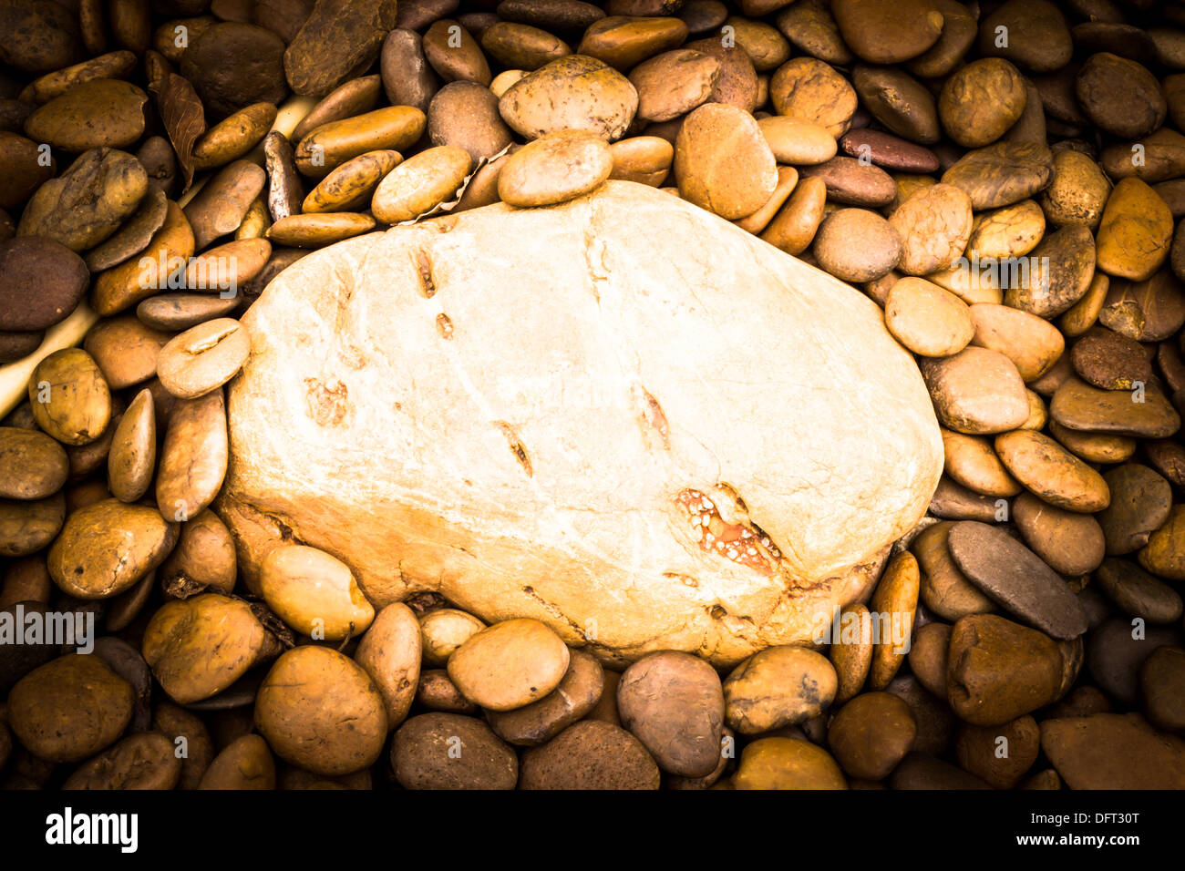 A big river stone on small river stone background Stock Photo - Alamy