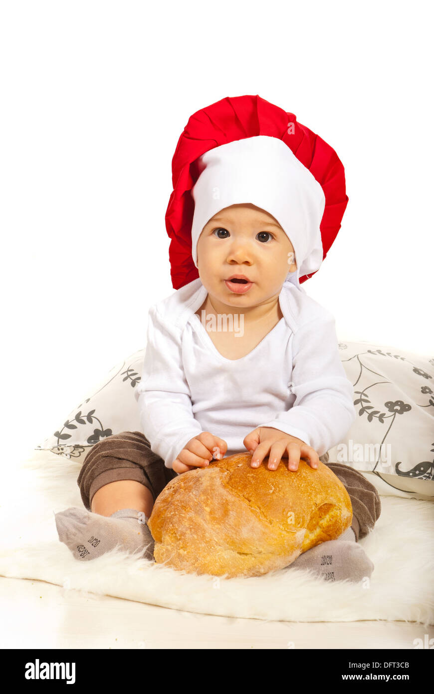 Adorable baby boy with chef hat holding bread Stock Photo - Alamy