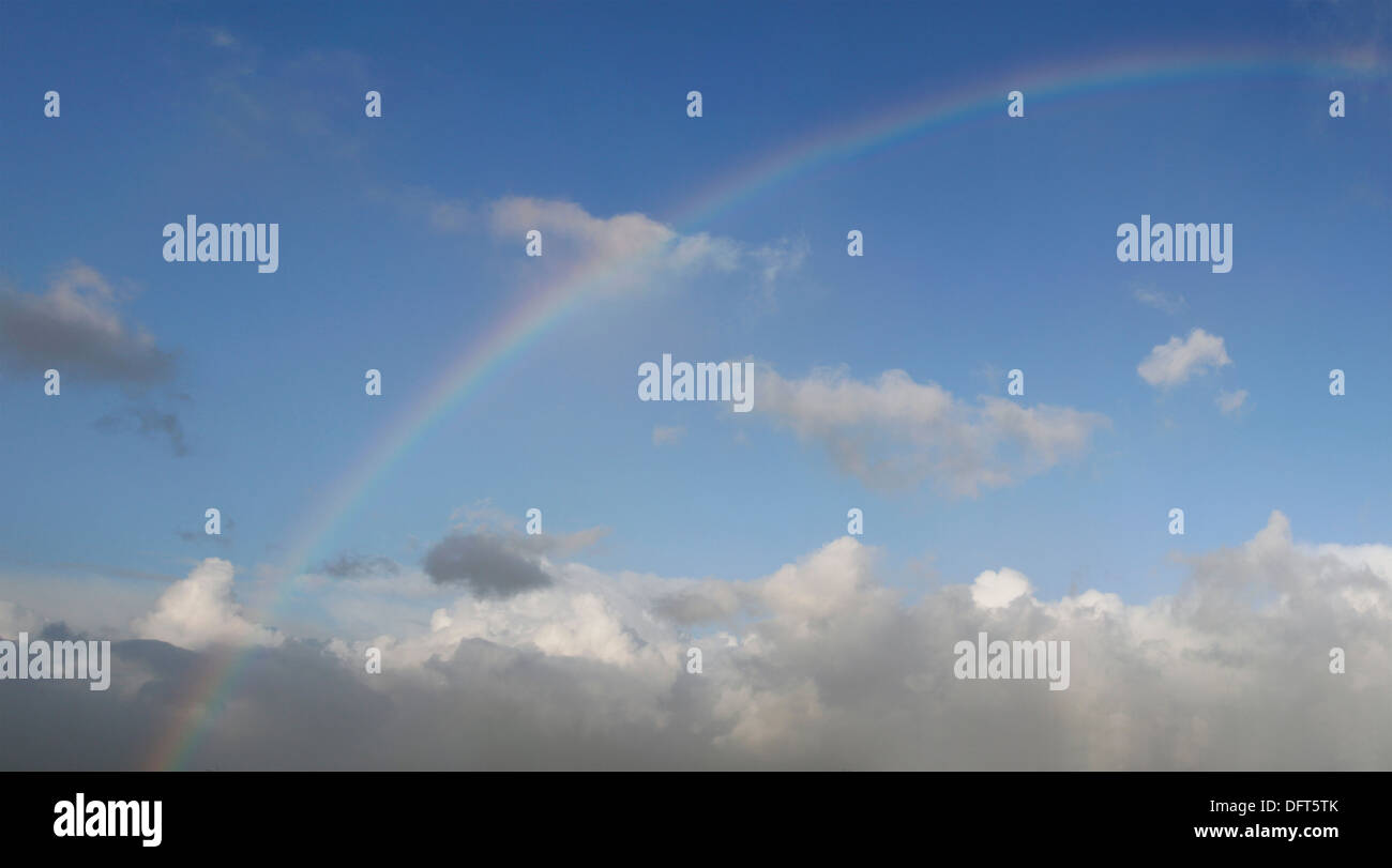 Rainbow in blue sky Stock Photo - Alamy