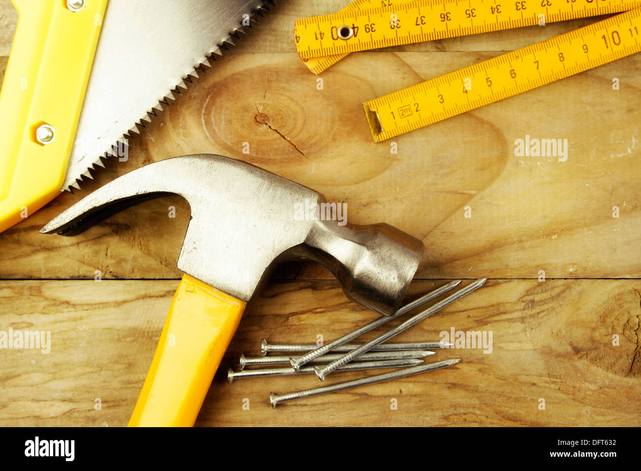 Hammer, nails, saw and folding ruler on wood Stock Photo - Alamy