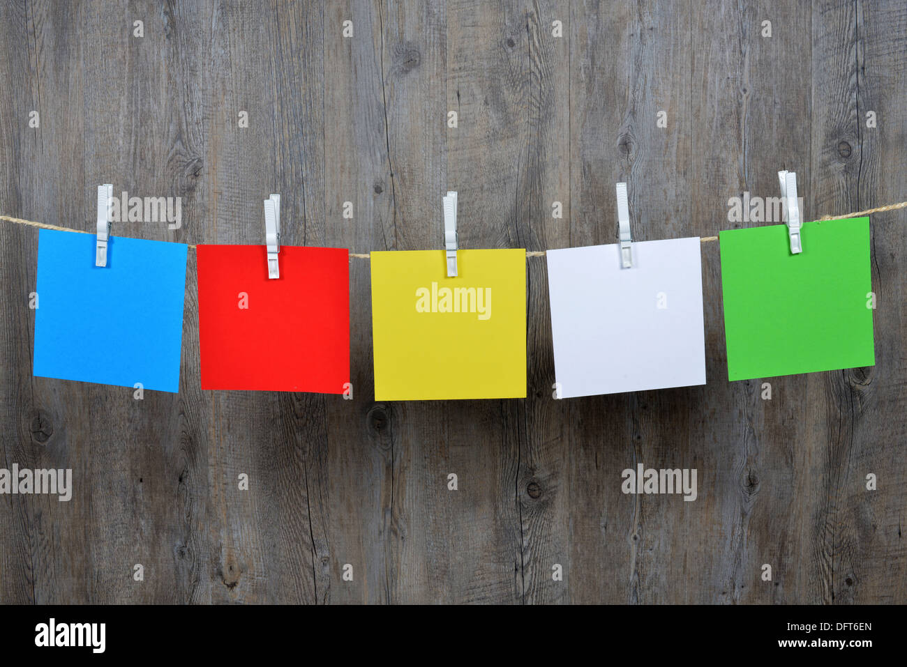 5 colored post it hanging on a clothesline Stock Photo - Alamy