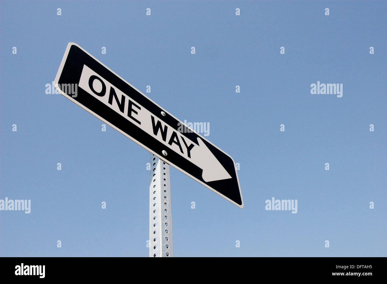 Roadway oneway sign showing which way to go on the streets Stock Photo ...
