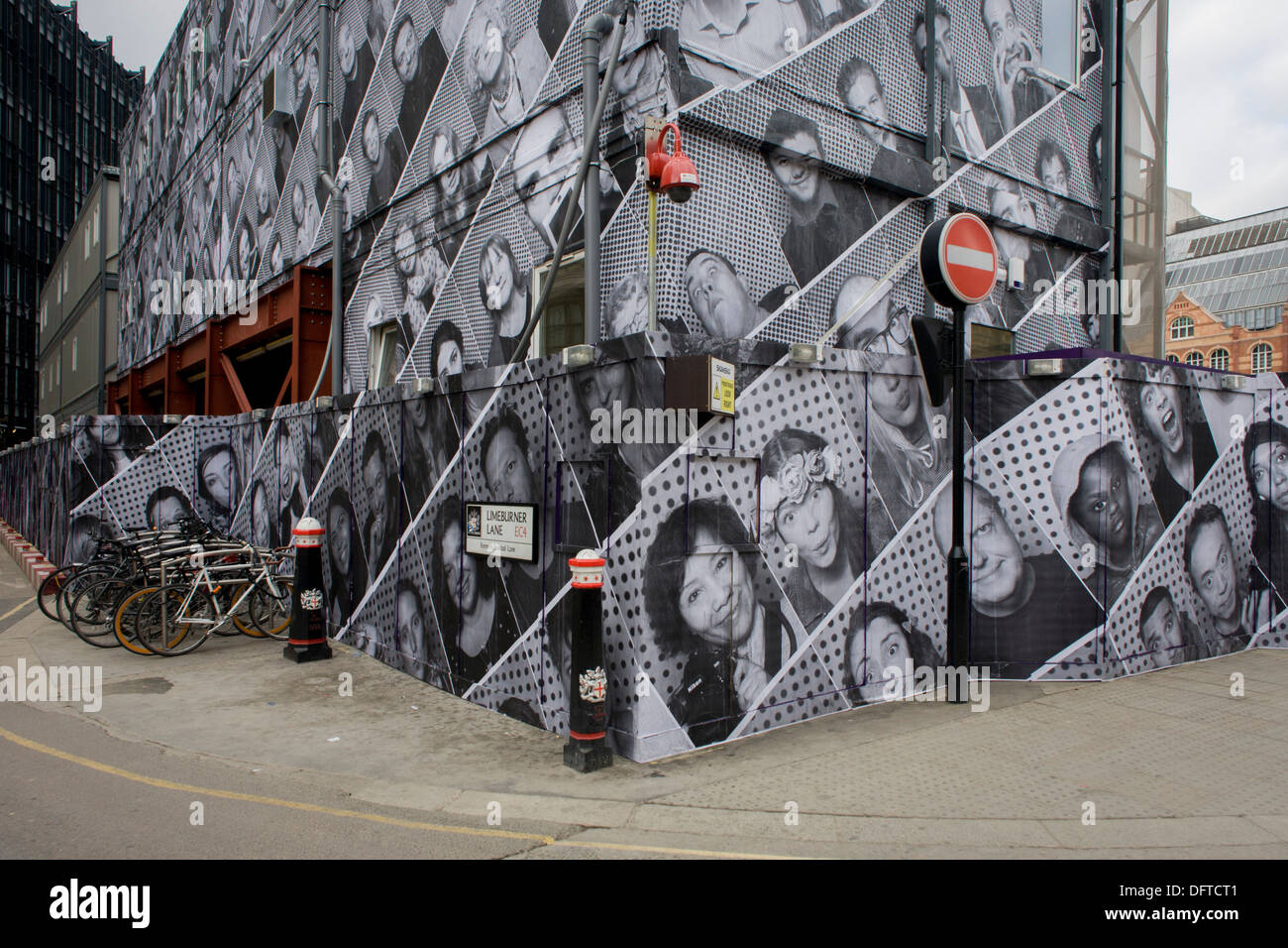 A construction hoarding featuring dozens of London faces in the City ...