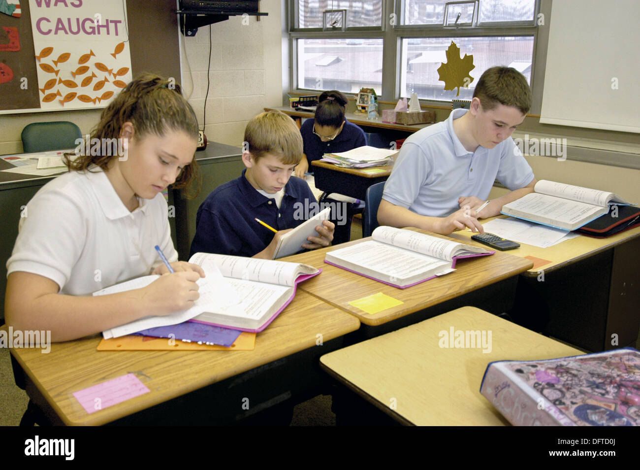 Seventh grade students learning maths by using calculators. Catholic ...