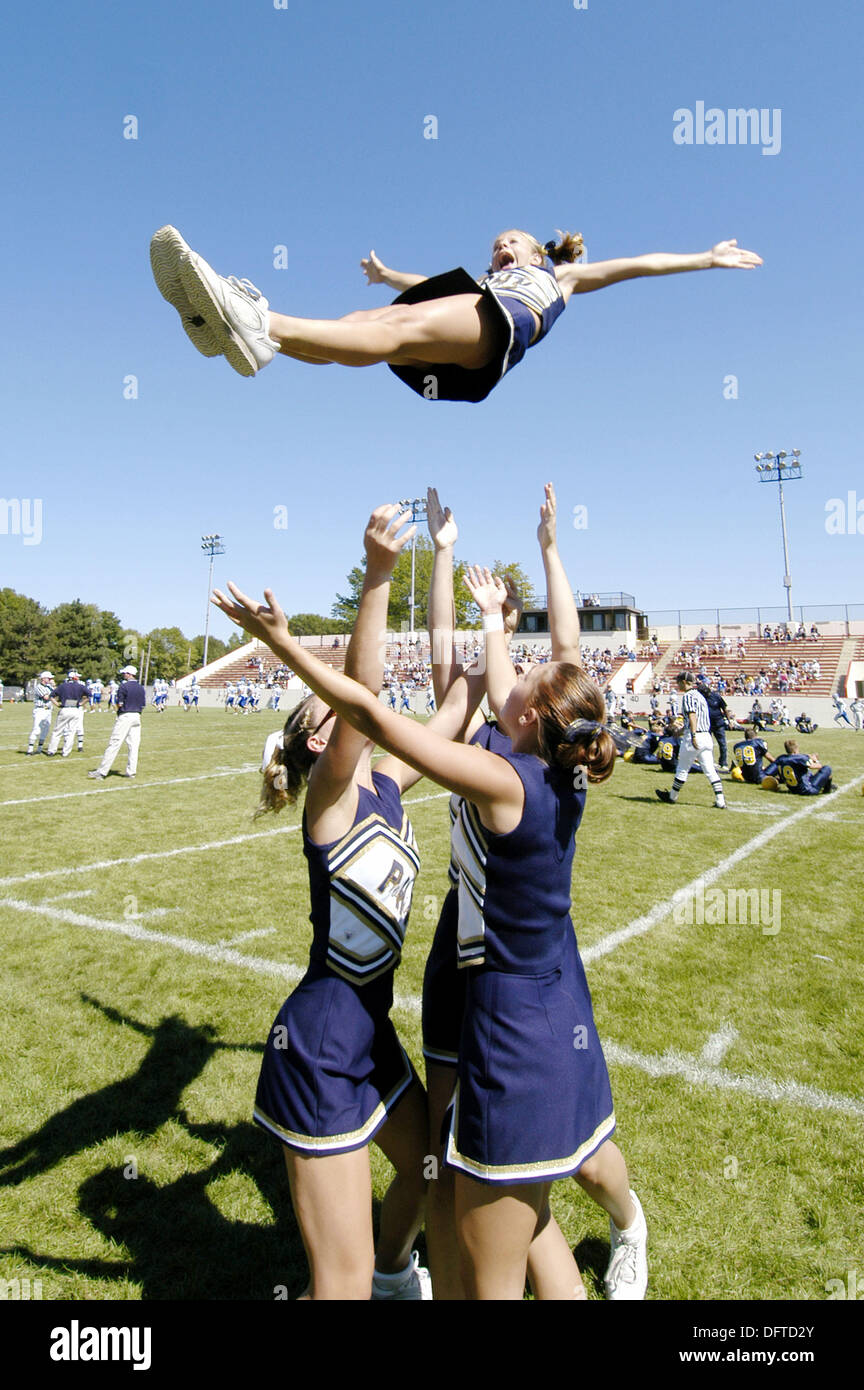 Cheerleaders performing during football game Stock Photo - Alamy
