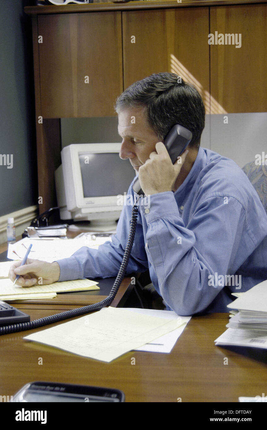 Male banker works at his desk Stock Photo - Alamy