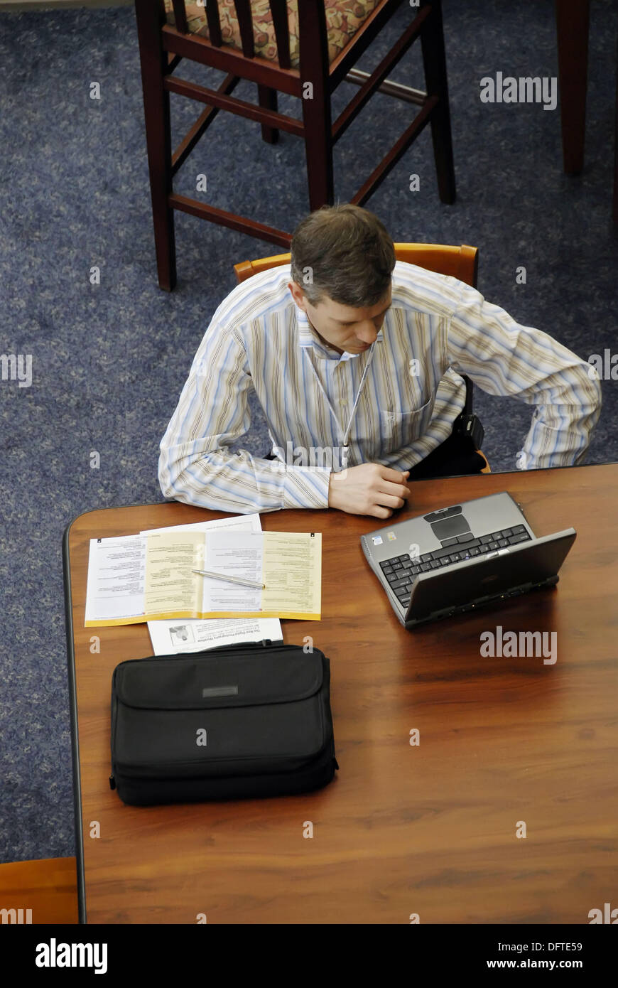 Adult businessman professional works on wireless laptop computer while ...