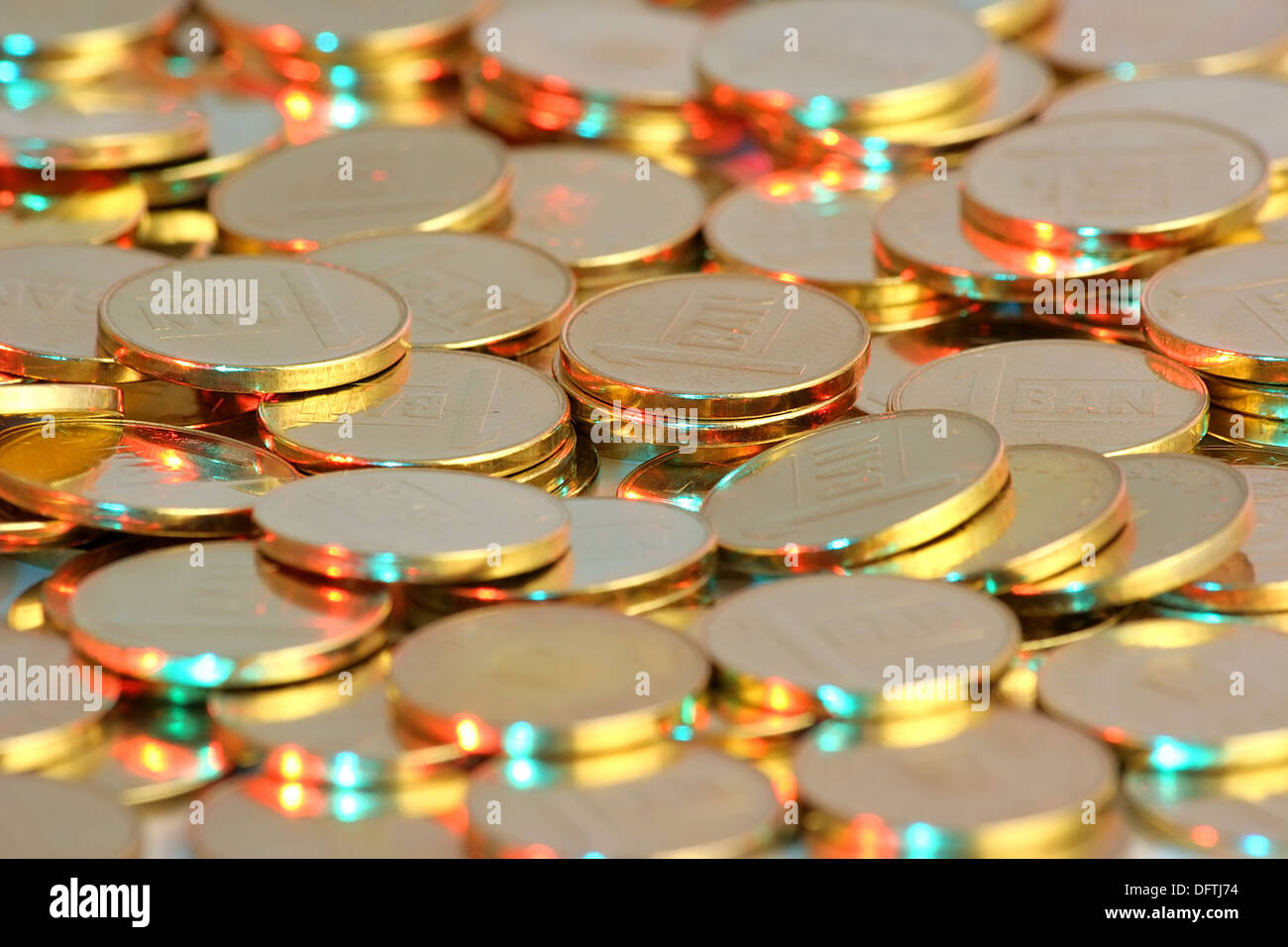 Golden coins illuminated with red and blue light Stock Photo - Alamy