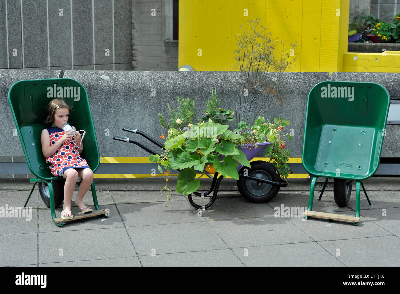 Girl sitting in wheelbarrow hi-res stock photography and images - Alamy