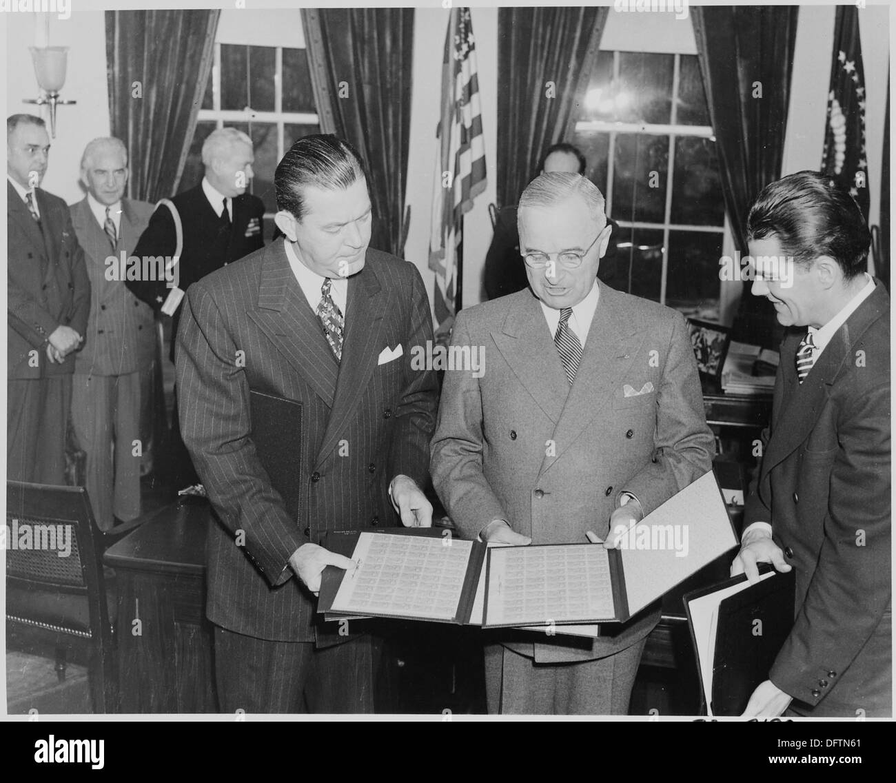 A photograph showing President Harry S. Truman receiving a ...