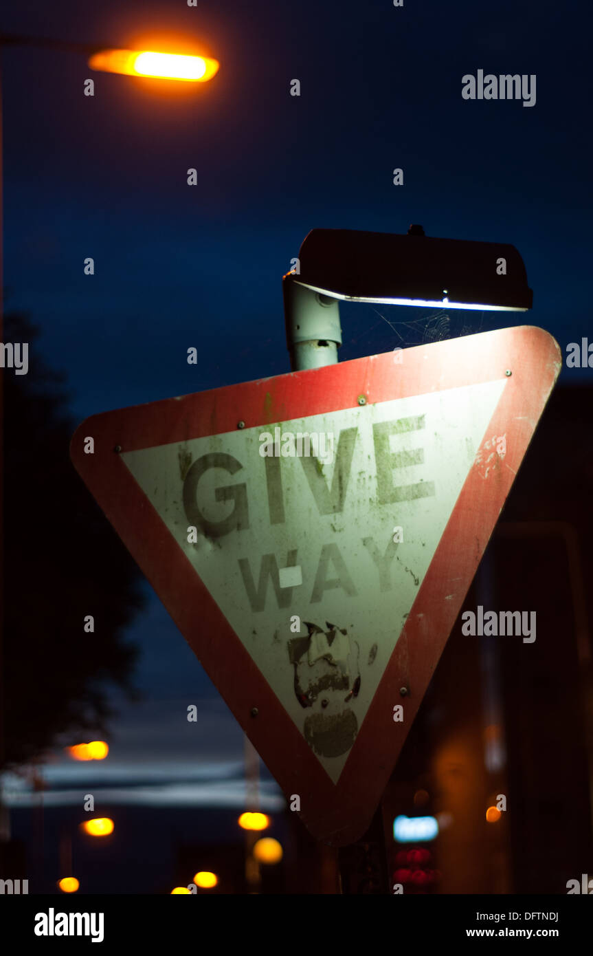 Give way sign at night Stock Photo - Alamy