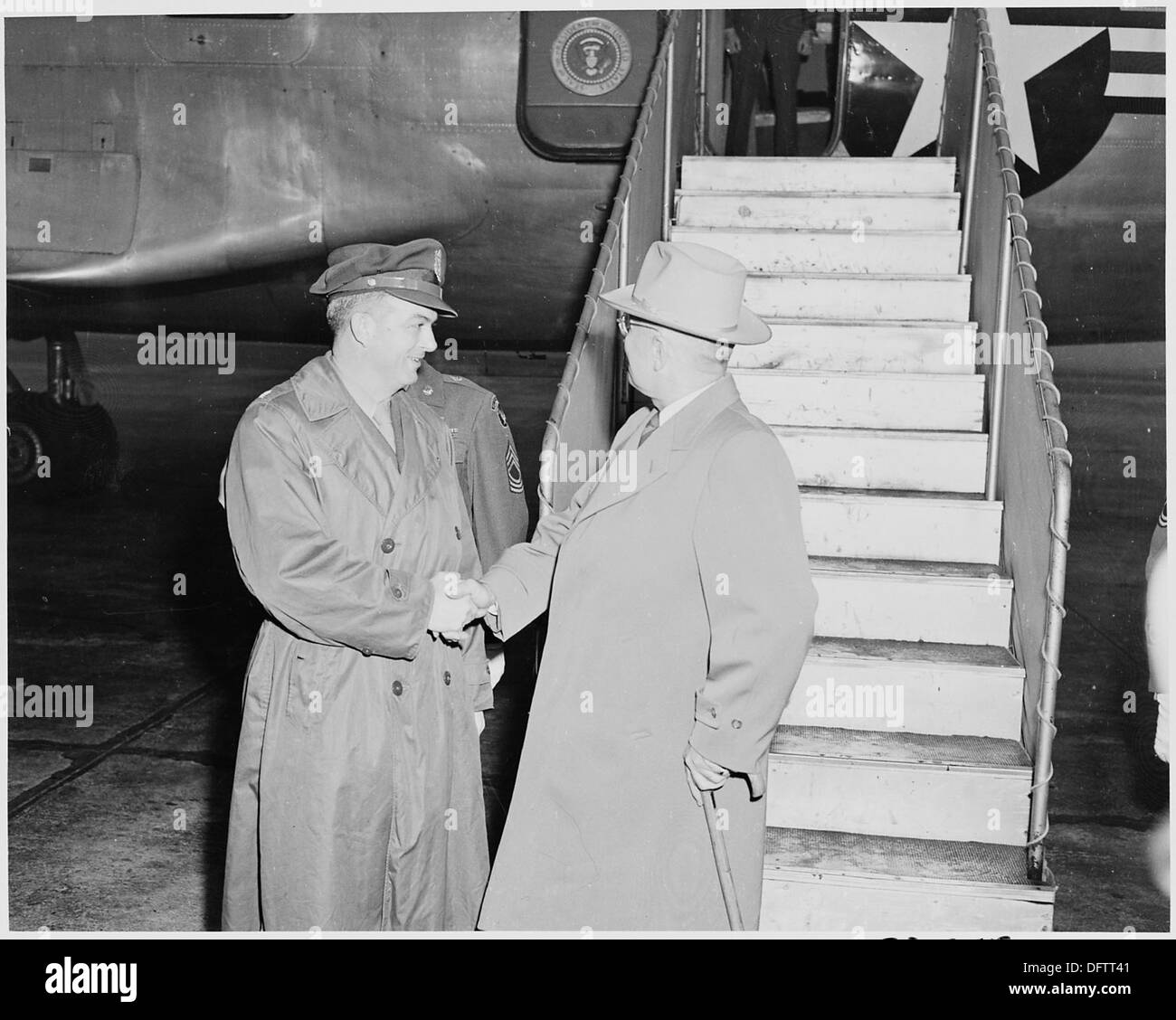 President Truman is seen shaking hands with pilot Henry at the bottom ...