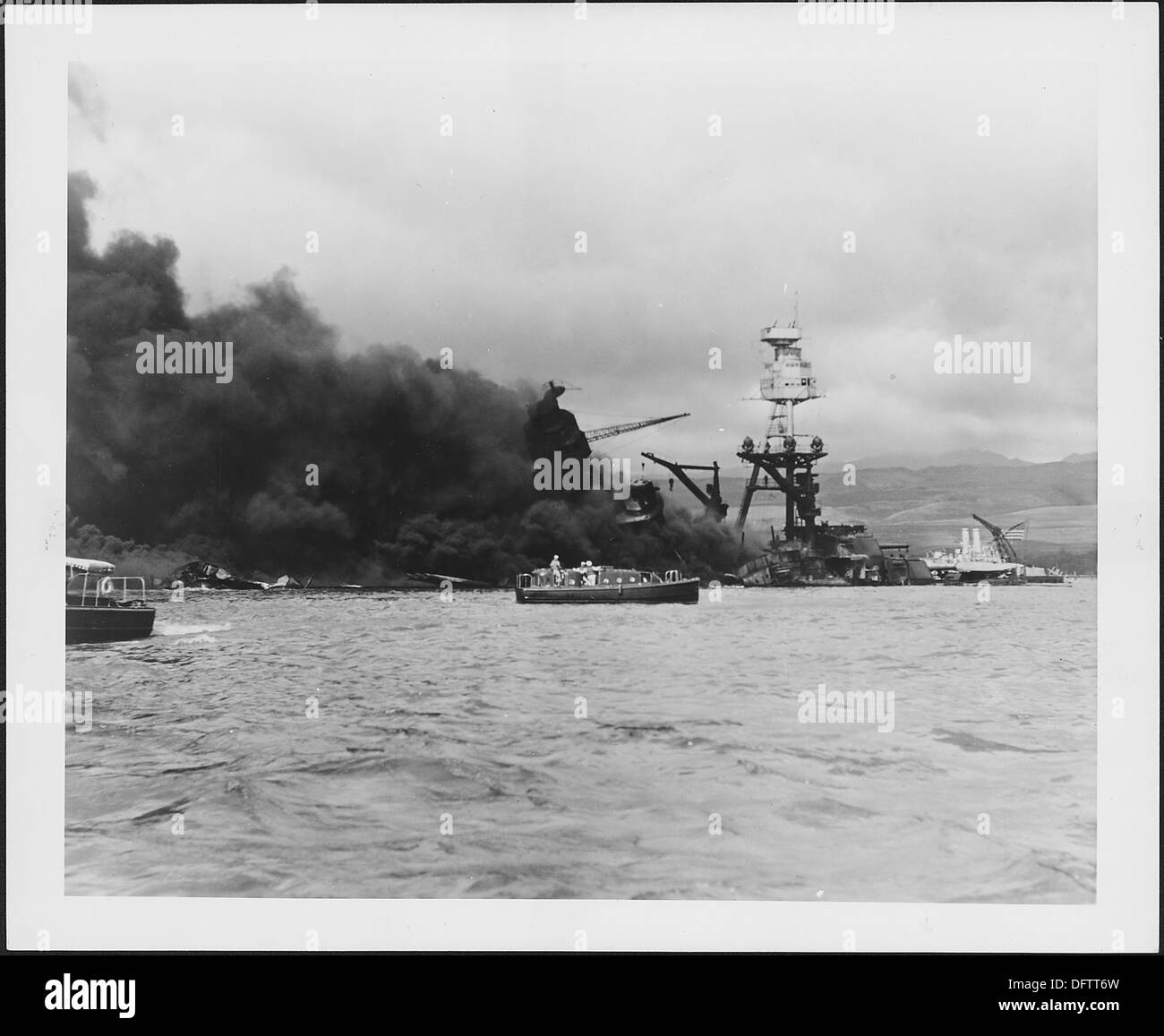 This photograph shows the USS Arizona on fire after the Japanese attack ...