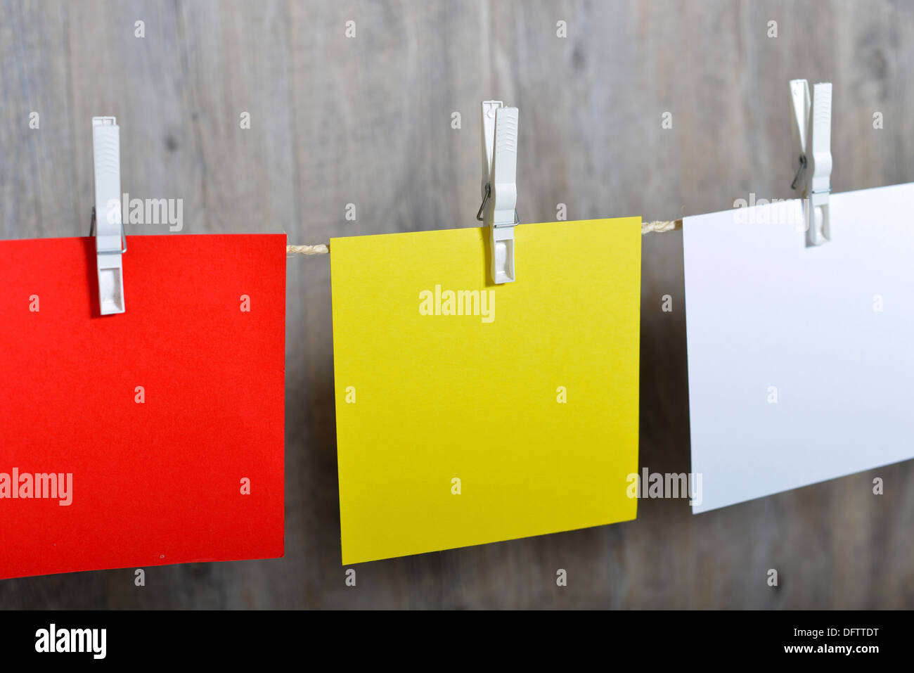 5 colored post it hanging on a clothesline Stock Photo - Alamy