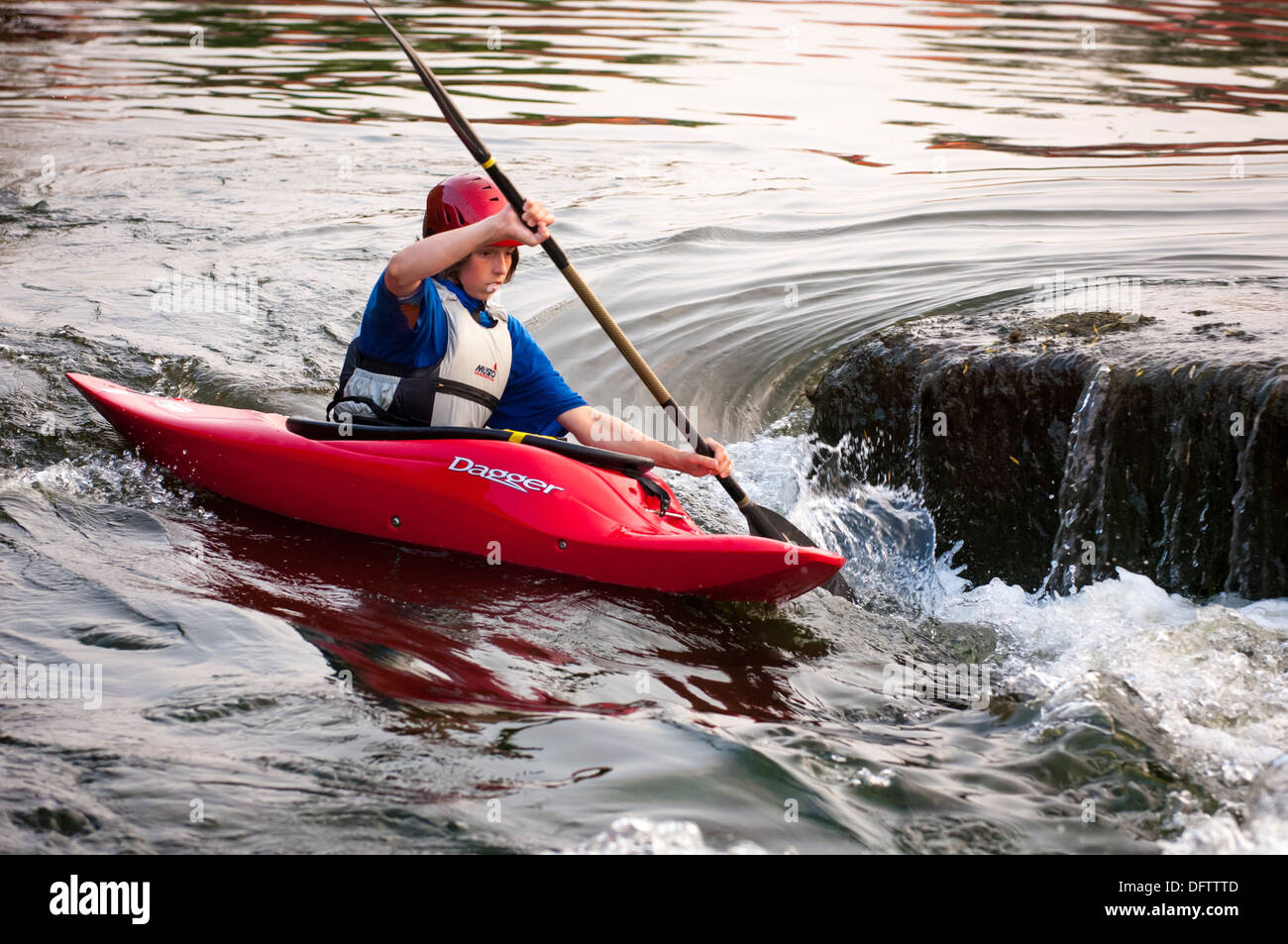 Young boy learning to kayak on white water Stock Photo - Alamy