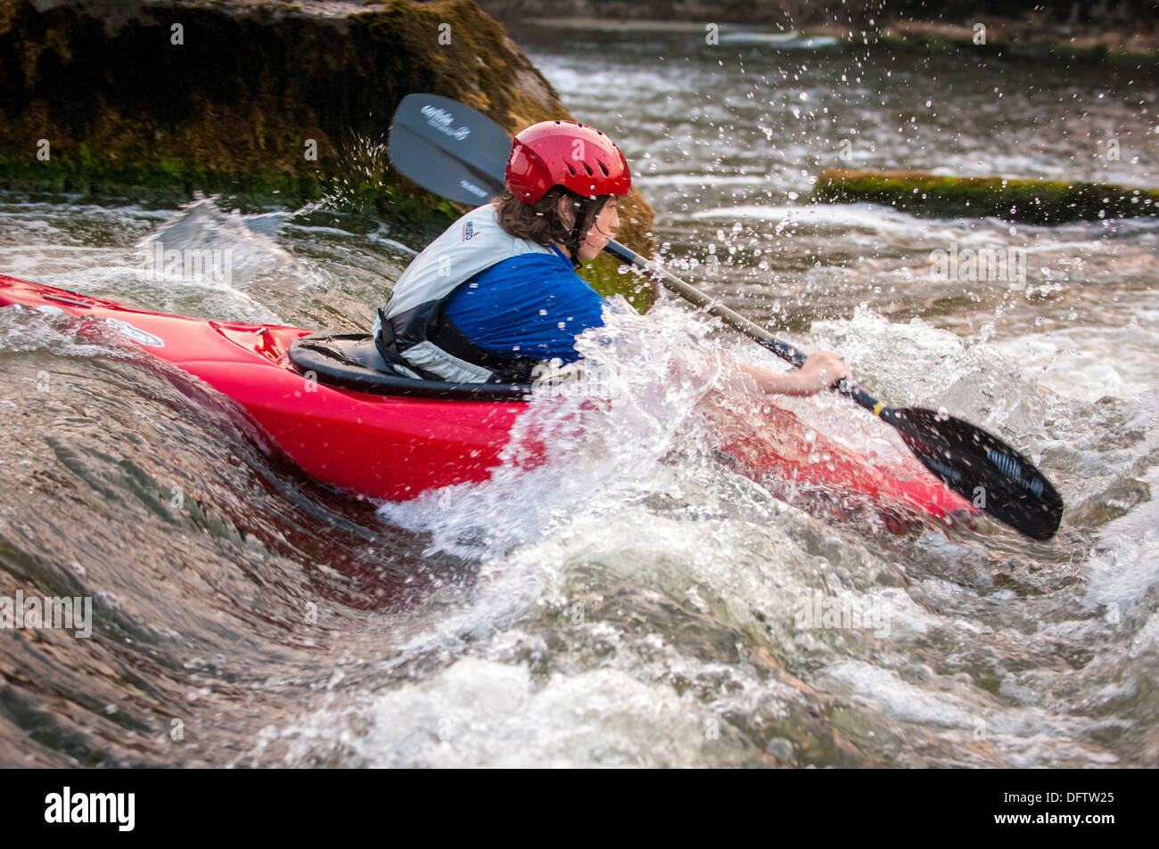 Young boy learning to kayak on white water Stock Photo - Alamy