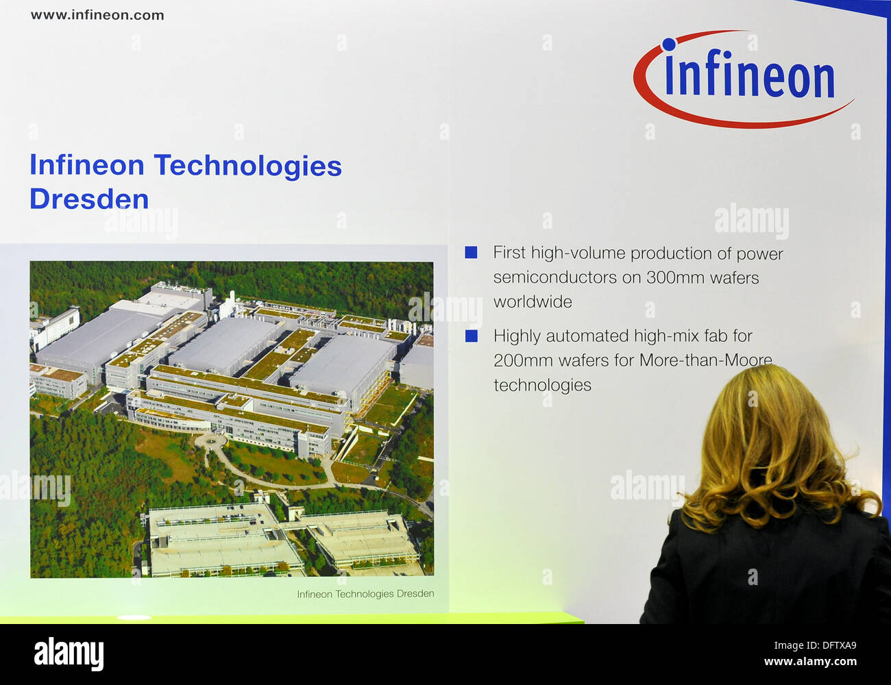 Dresden, Germany. 09th Oct, 2013. A woman stands next to the booth of ...