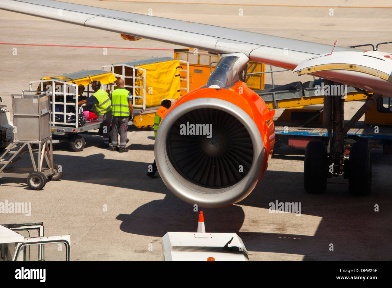 Baggage being loaded onto an aircraft at the airport prior to take off ...