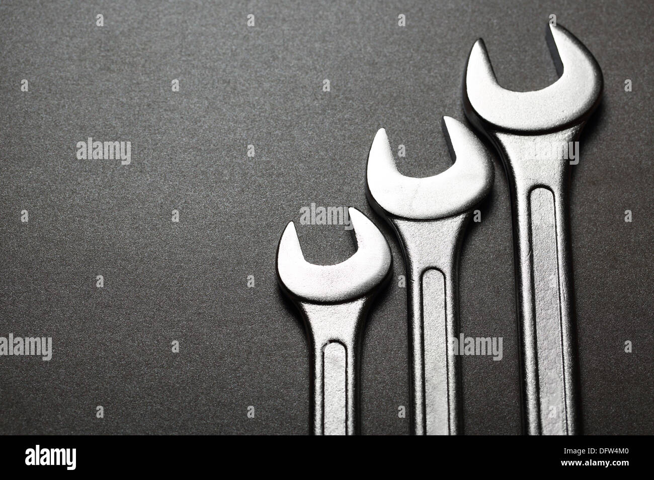 Screw keys on black background Stock Photo - Alamy