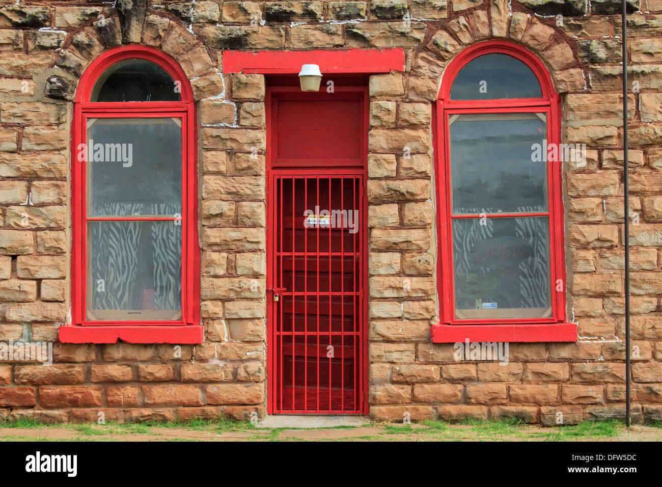 Bright red windows and door in an old sandstone building Stock Photo ...