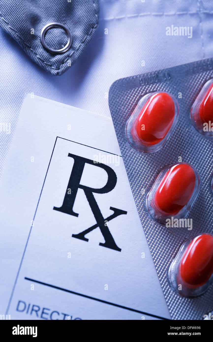 Red pills and patient list on doctor's smock Stock Photo - Alamy