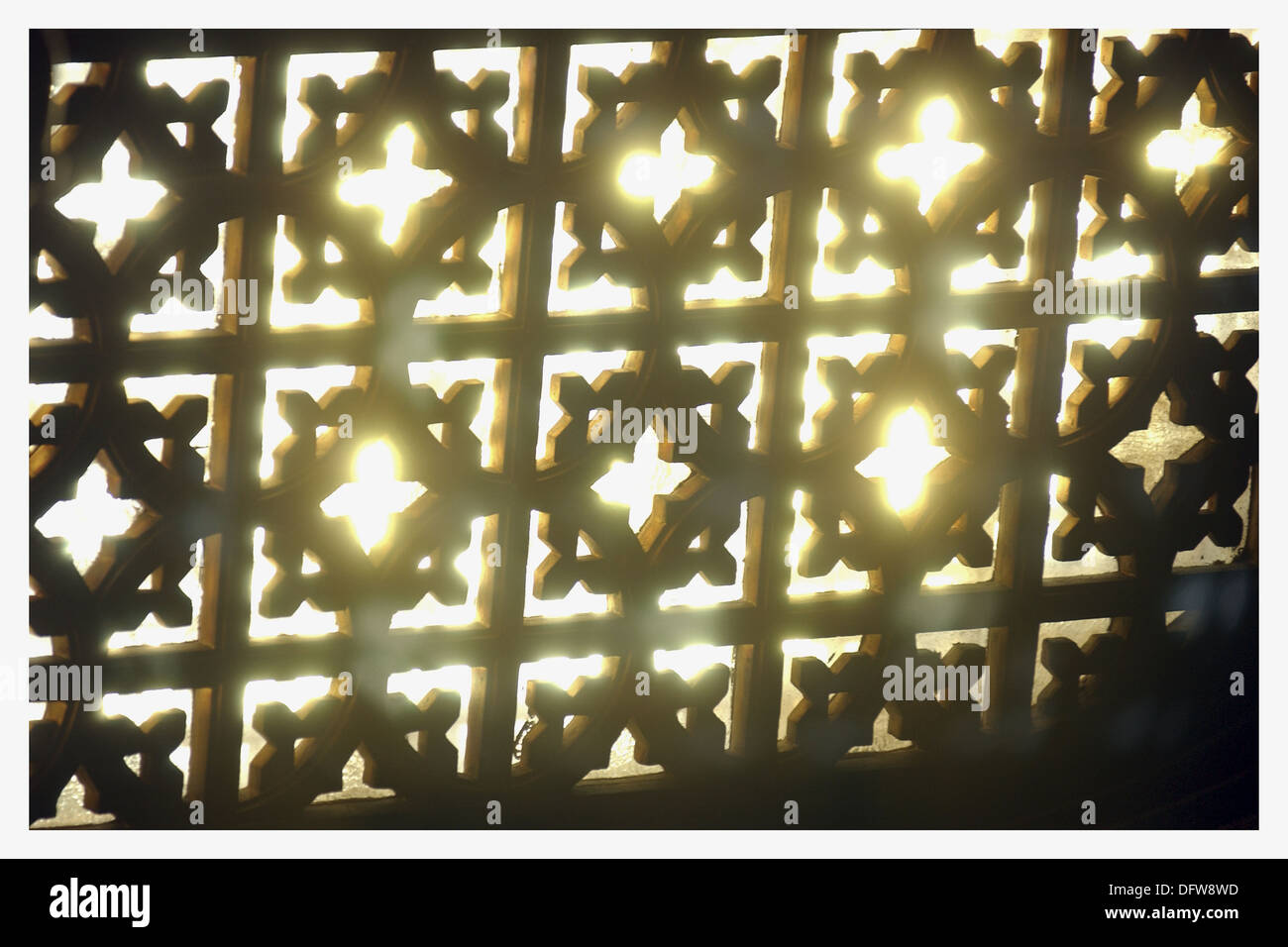 Cathedral window with sunlight seeping in through decorative crosses ...
