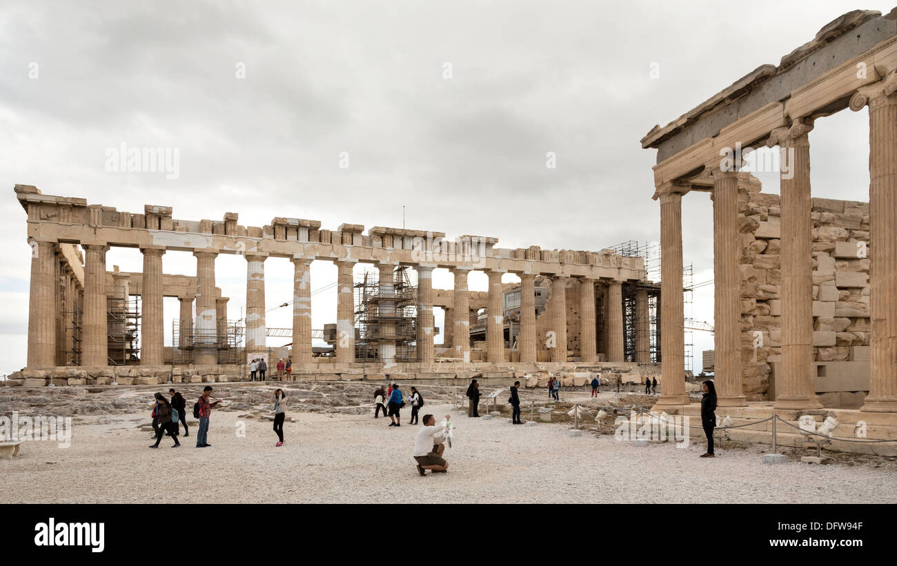 People stand in front of the ancient Temple of Parthenon atop the ...