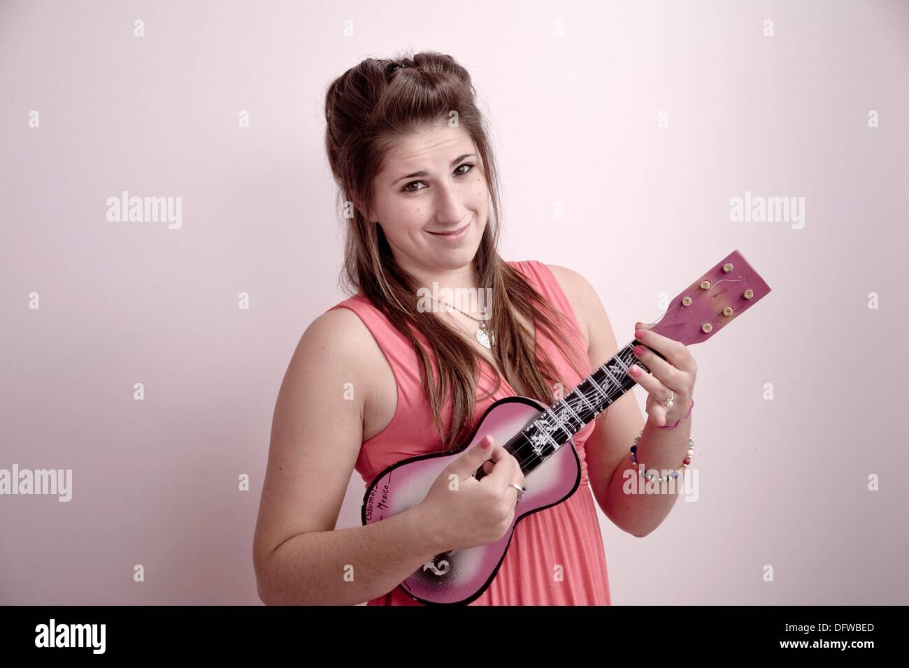Girl playing a ukulele hi-res stock photography and images - Alamy